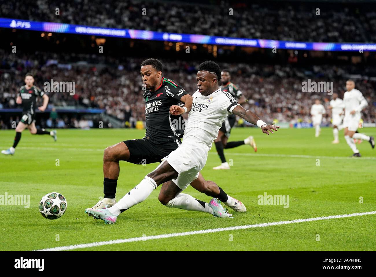 Real Madrid's Vinicius Junior (right) and Arsenal's Jurrien Timber ...