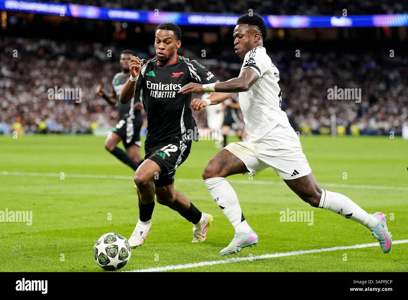 Real Madrid's Vinicius Junior (right) and Arsenal's Jurrien Timber ...