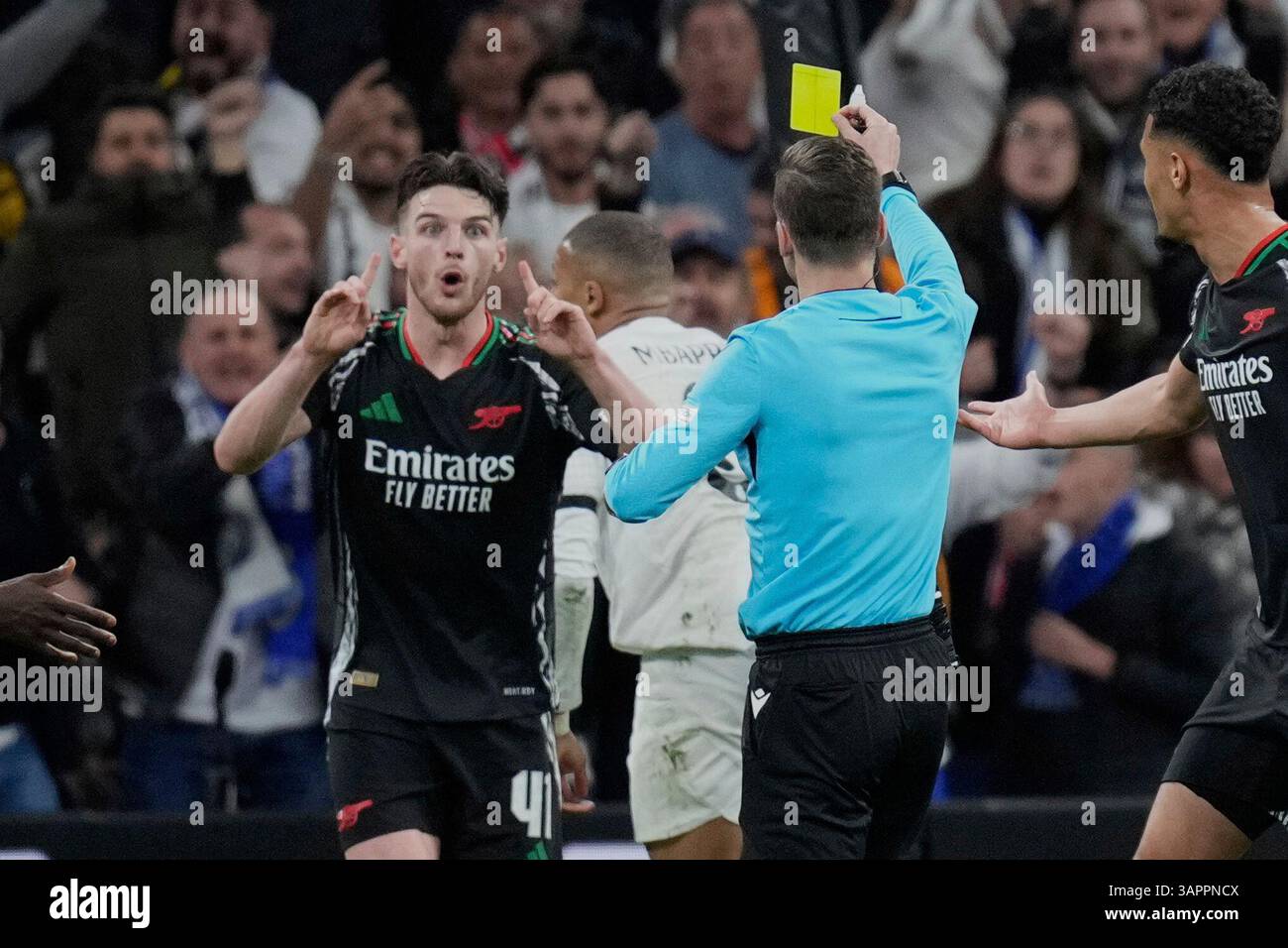Referee Francois Letexier shows a yellow card to Arsenal's Declan Rice ...