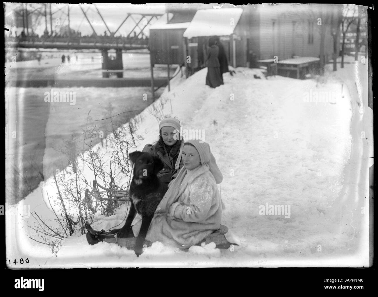 Two small girls in winter clothes are pictured standing on the bank of ...