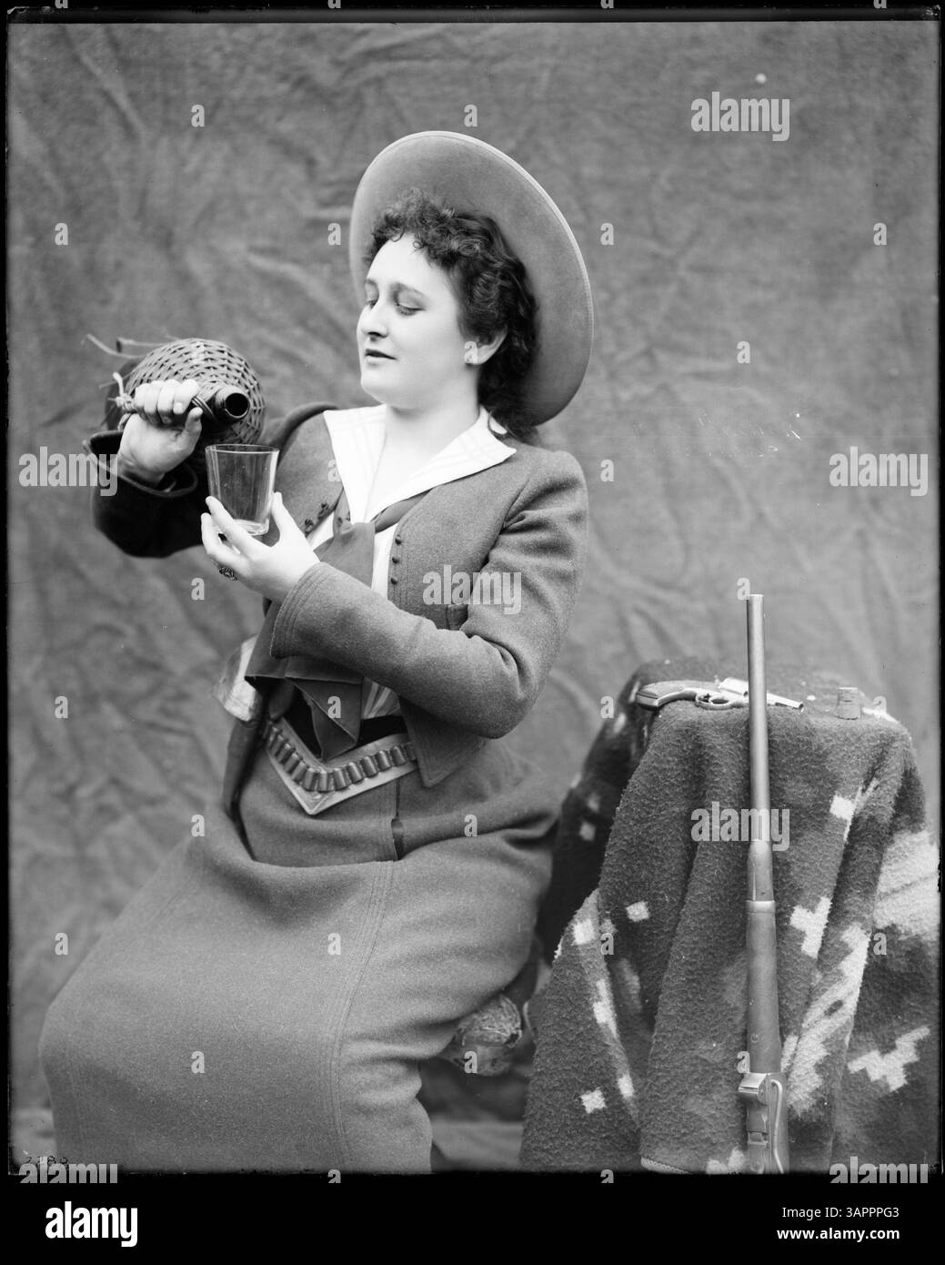 Portrait of Alice Archer, dressed in a shooting costume and fascinator ...