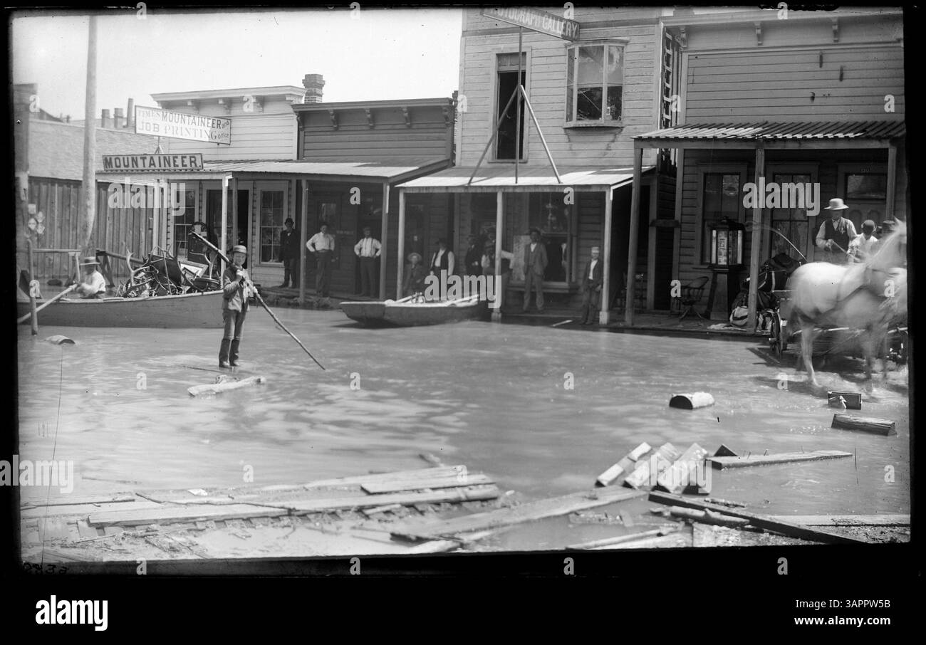 This photograph shows a flooded city street, named 'Mountaineer.' The ...