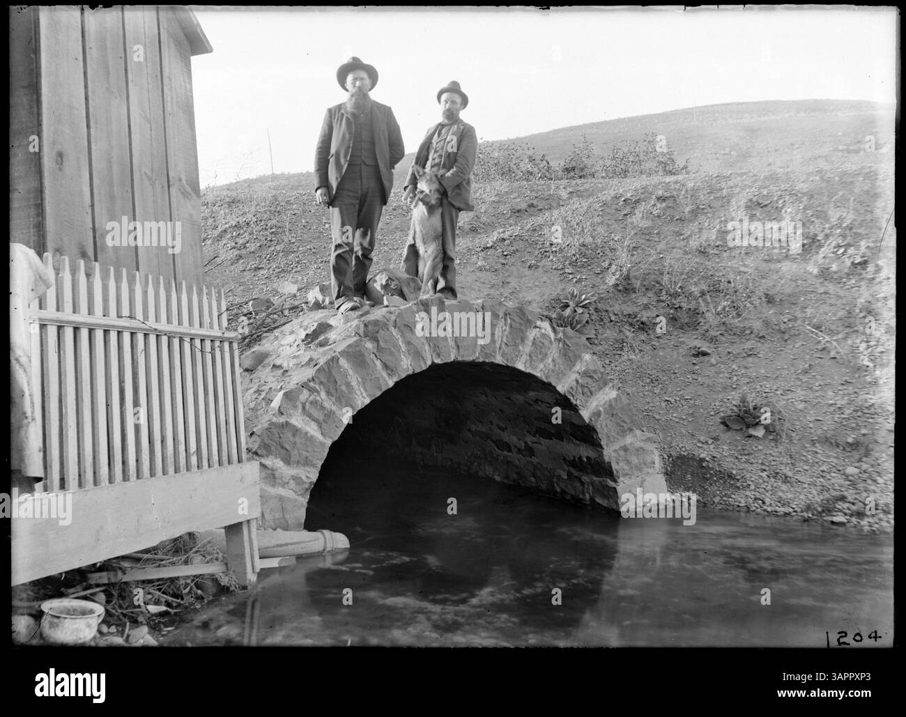 A photograph featuring two hunters with a dog, showcasing a moment in a ...