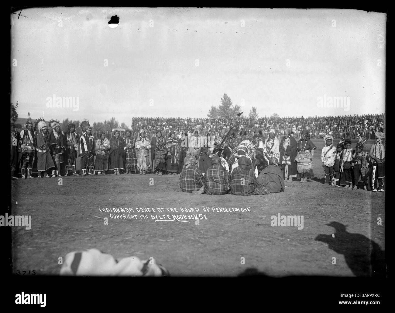 This photograph shows an Indian dance at the Roundup, capturing the ...