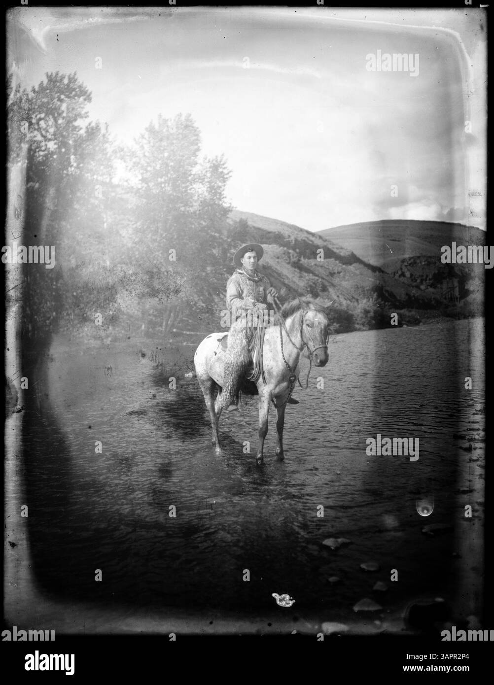 This photograph shows Munshang, a cowboy on horseback. The image offers ...