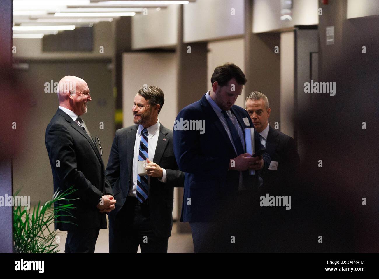 Senator Todd Young, R-Ind., 2nd from left, talks in a hallway, before ...