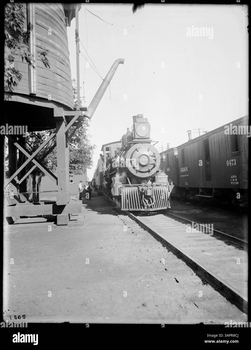 The photograph features O.R.&N. engine no. 134 alongside boarding car ...