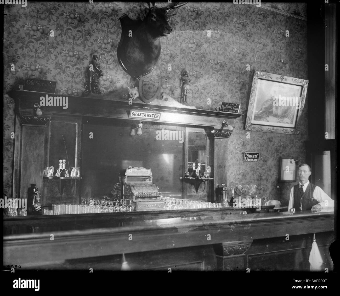 This photograph depicts the interior of a saloon, with a bar and ...