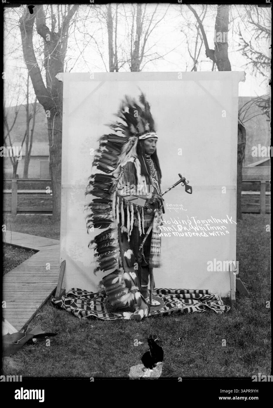Photograph of a Native American man holding the tomahawk allegedly used ...