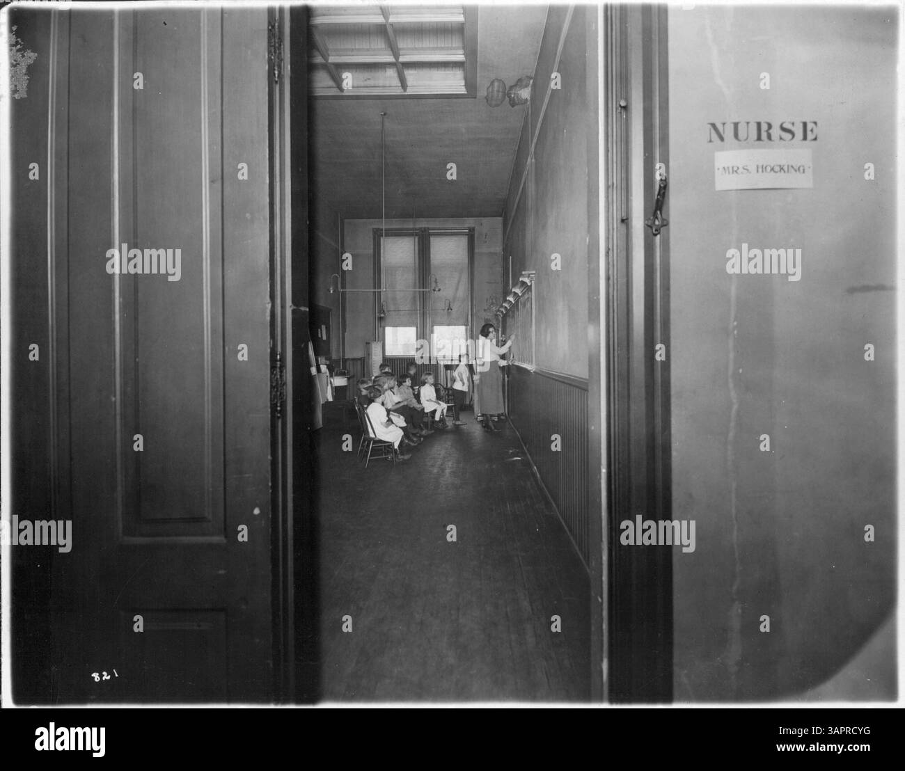 A classroom scene at Emerson School, showing the school nurse, Mrs ...