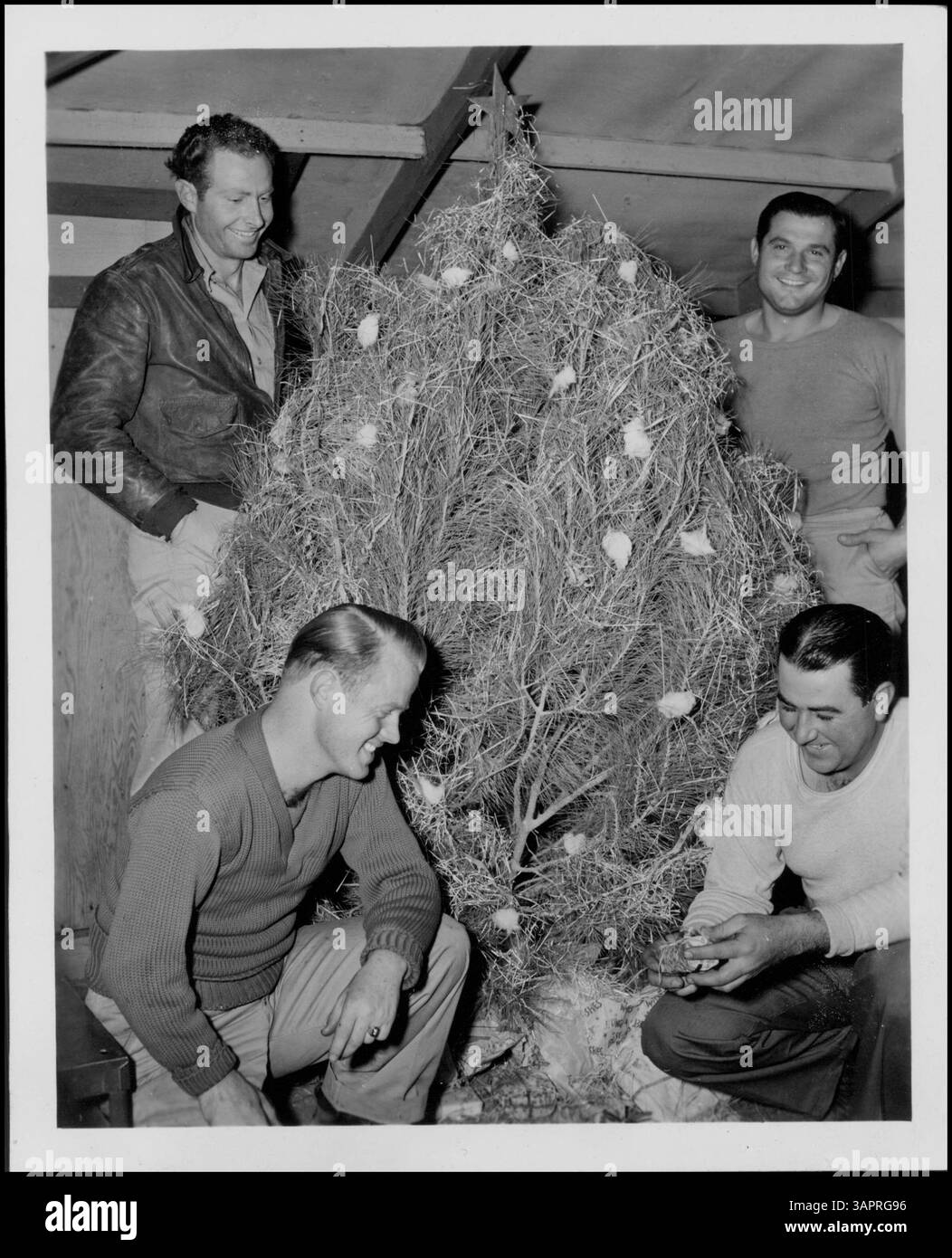 A group of mechanics from the 15th Air Force in Italy stand around a ...