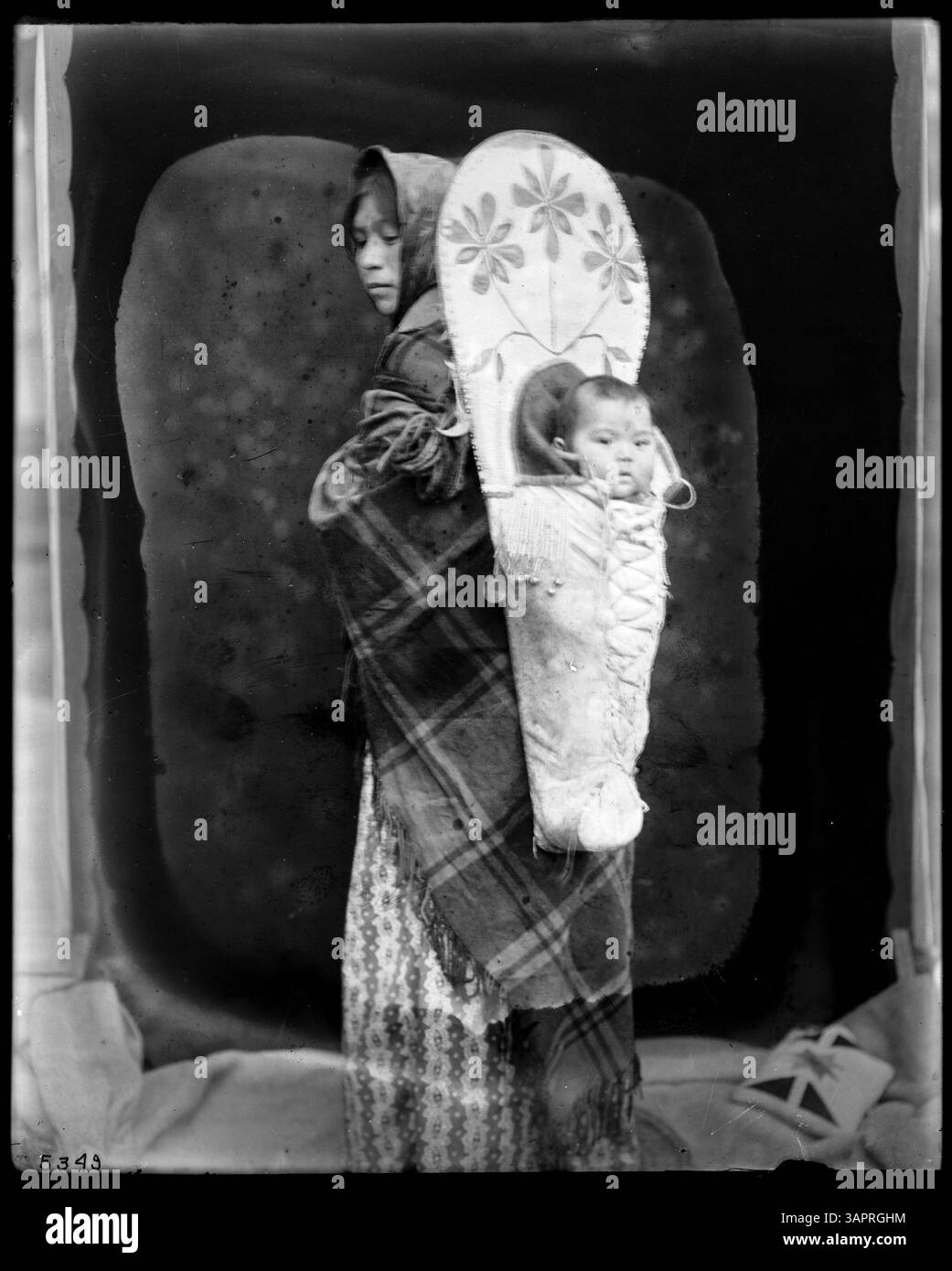 This photograph by Lee Moorhouse shows a tribal woman with an infant in ...