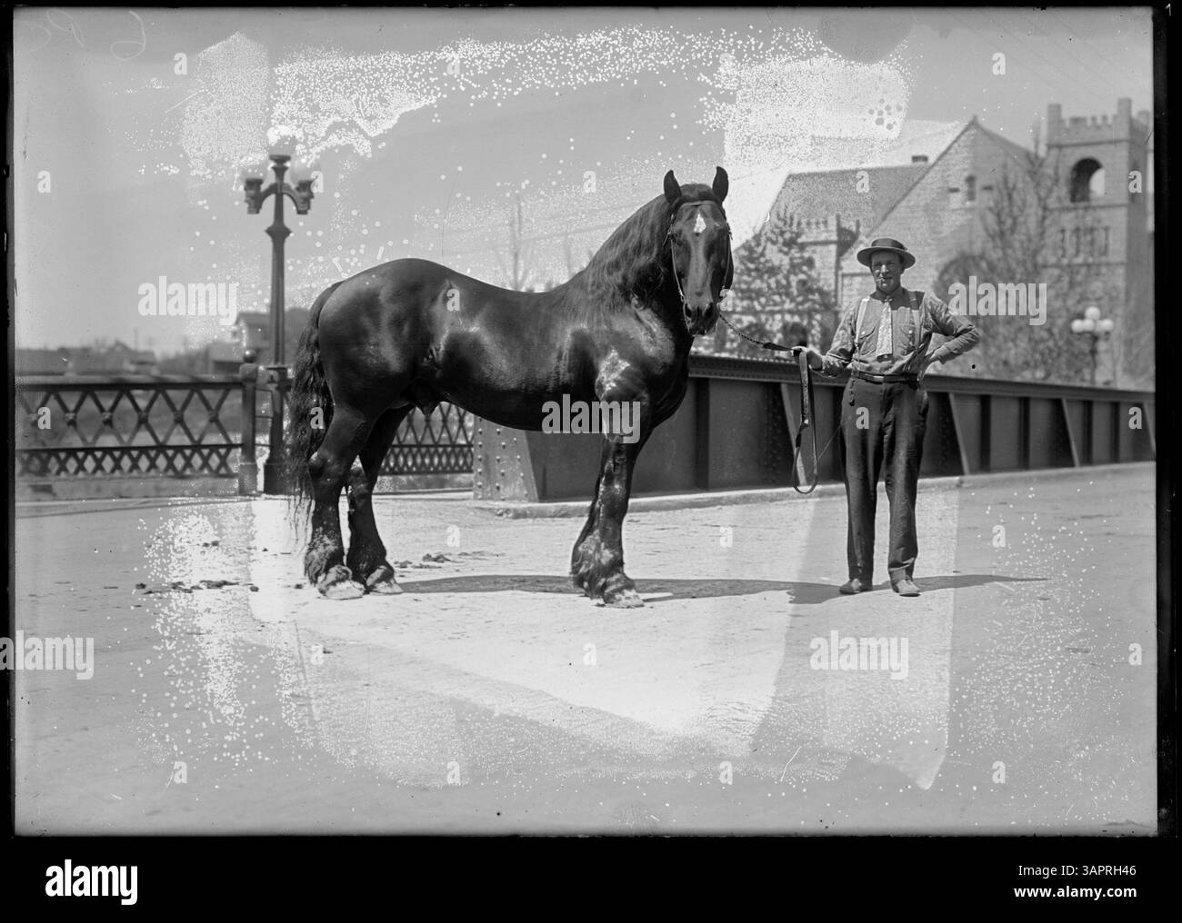 This photograph, *PH036 6309*, by Lee Moorhouse, shows a man standing ...