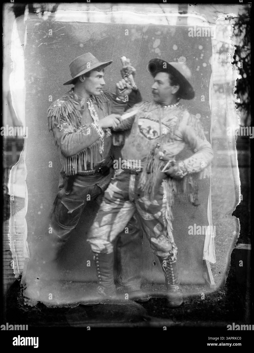 A dramatic photograph by Lee Moorhouse showing two cowboys posed in a ...