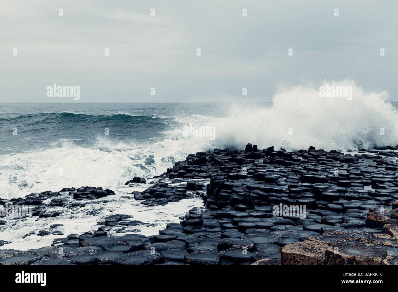 Waves crashing against rugged dark hi-res stock photography and images ...