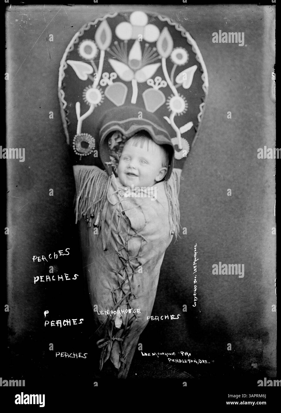 This photograph captures tribal infants in cradles, offering a poignant ...