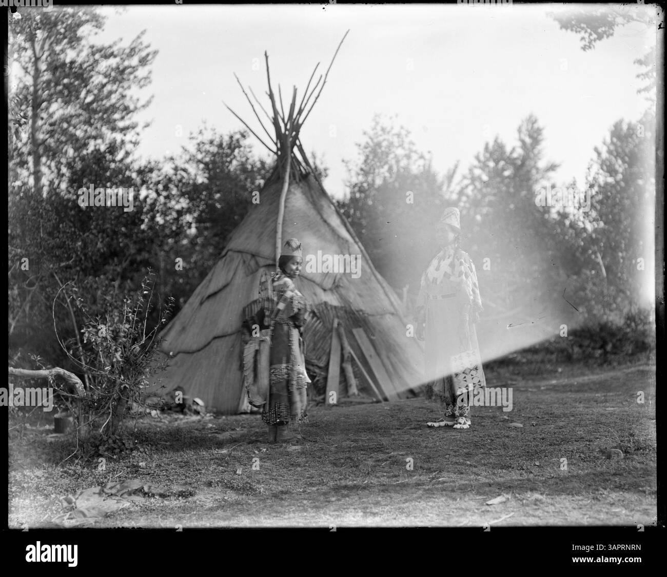 Photograph of two Native American women standing in front of a tipi ...