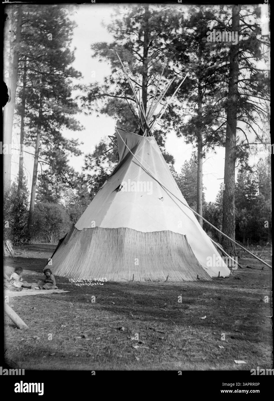 Photograph by Lee Moorhouse showing two children standing near a tipi ...