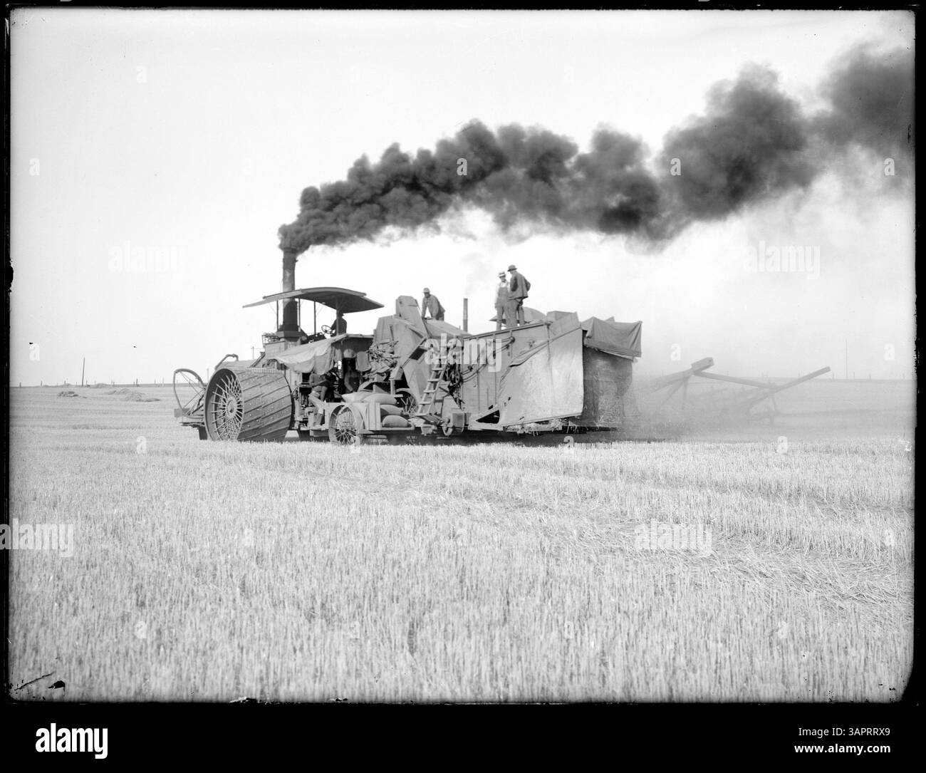 Photograph of a steam tractor drawn combine, captured from the left ...