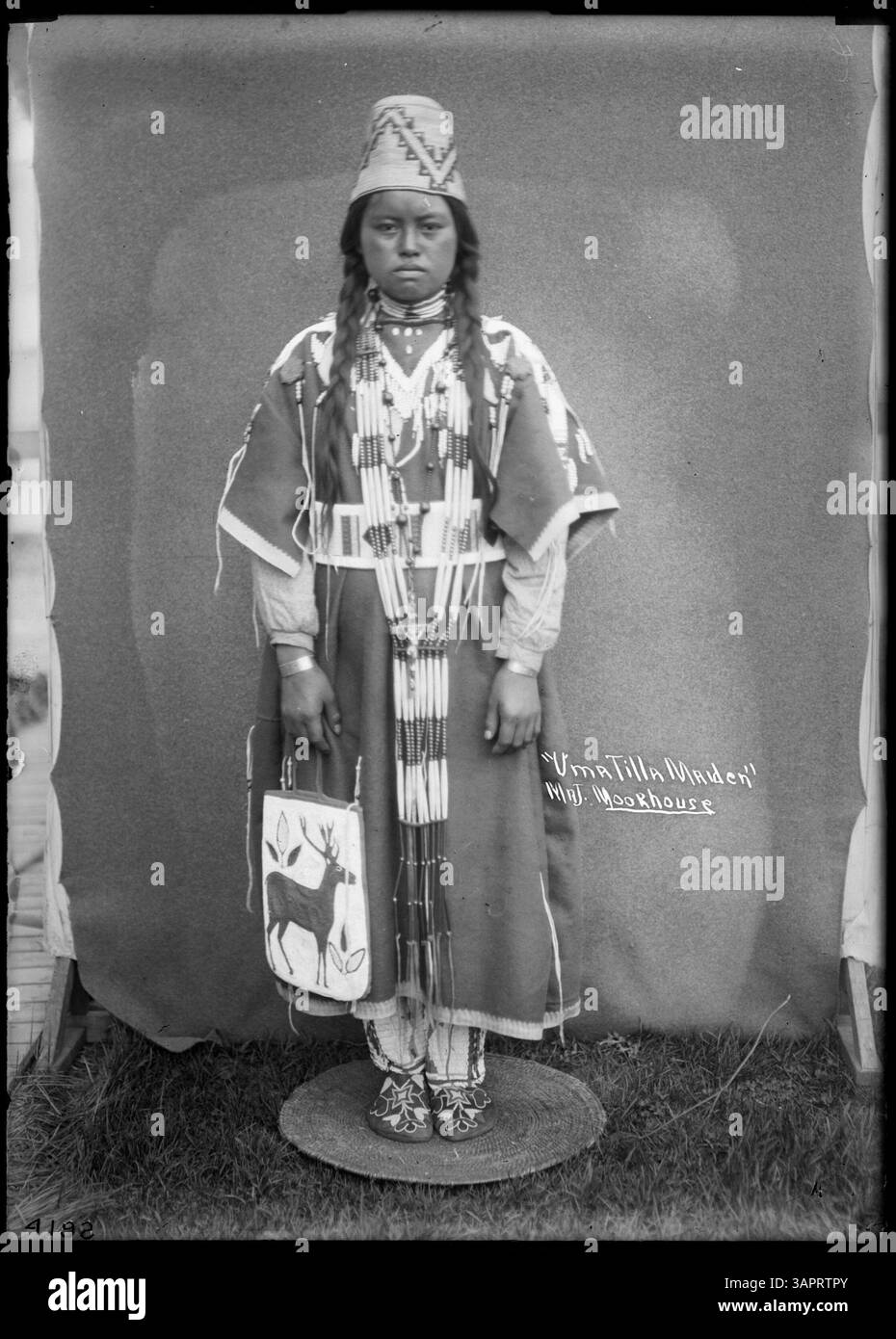 The photograph features Ruth Coyote, a Cayuse woman, dressed in ...