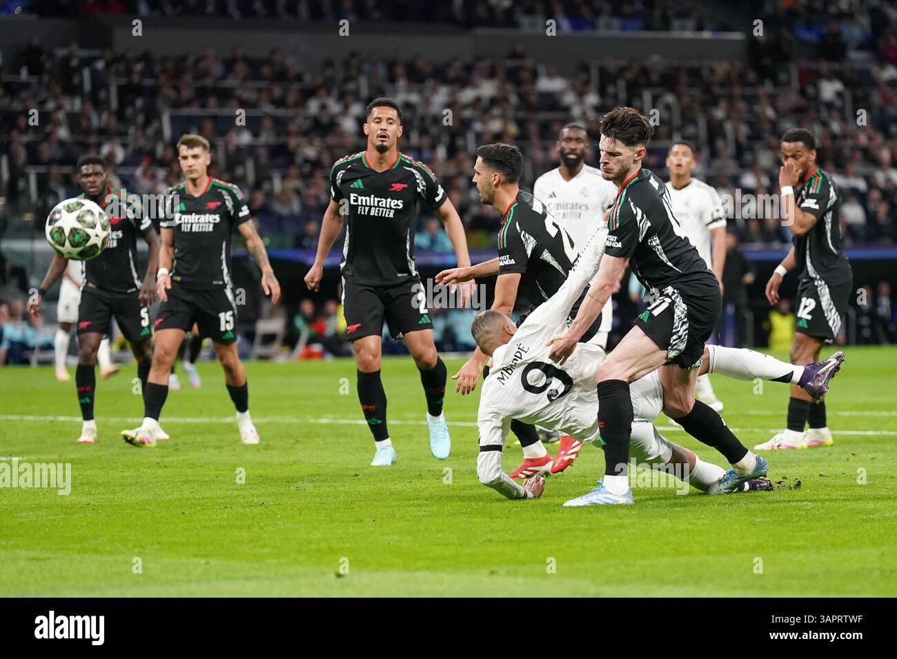Real Madrid's Kylian Mbappe is fouled by Arsenal's Declan Rice (right ...