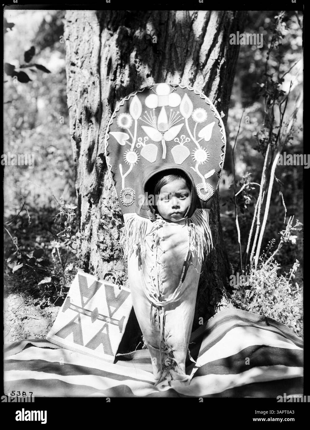 This photograph by Lee Moorhouse shows tribal infants in cradles ...