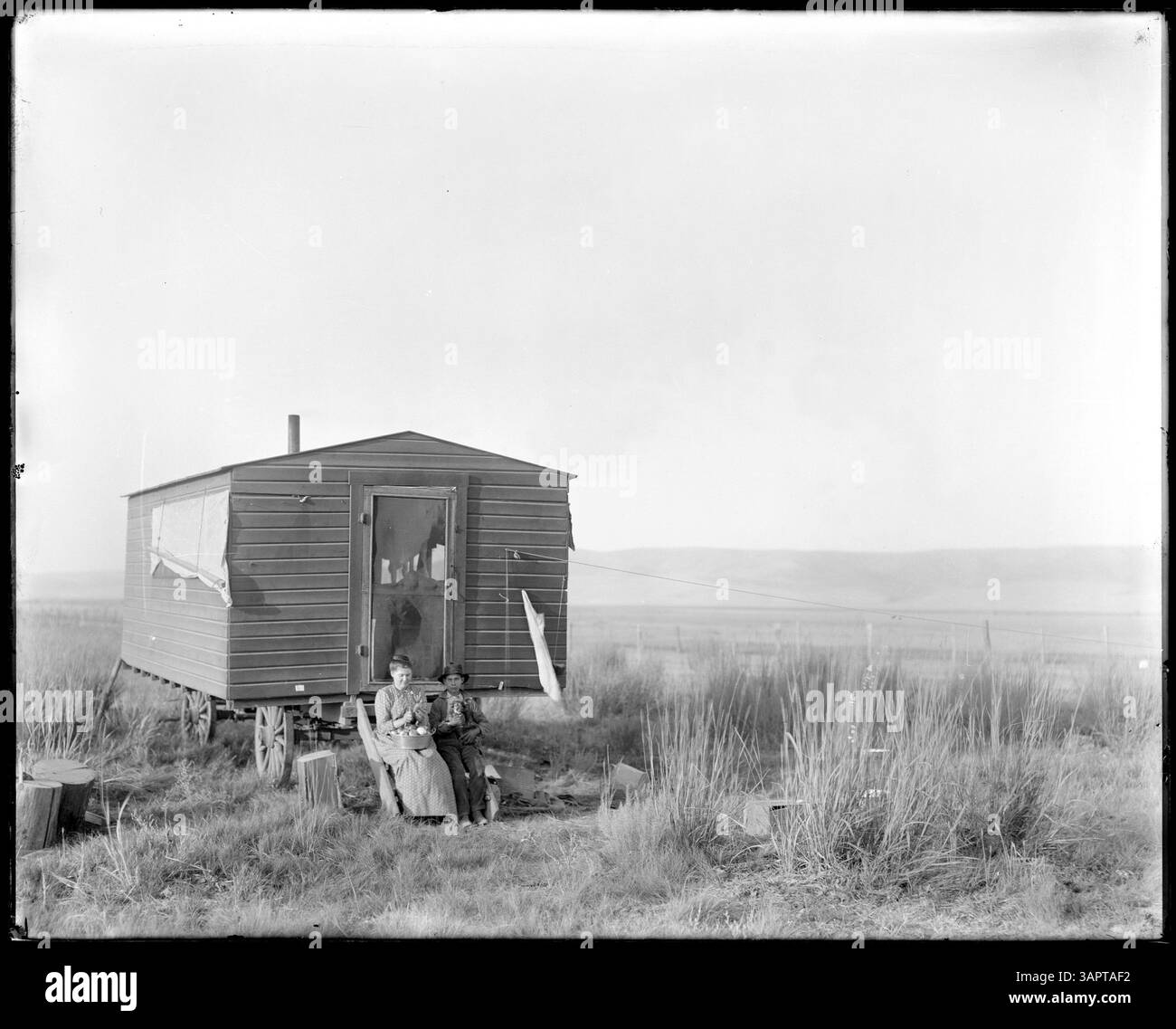 This photograph by Lee Moorhouse shows a chuck wagon with a threshing ...