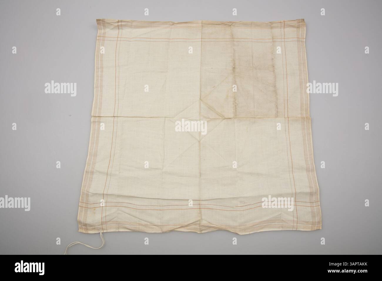 This off-white linen handkerchief with brown stripes belonged to ...