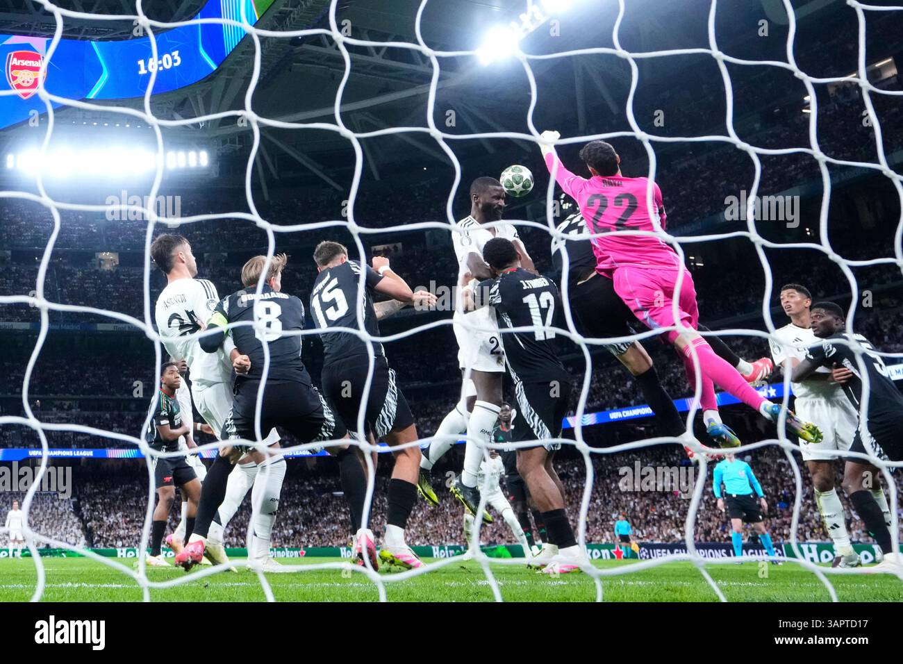 Arsenal's goalkeeper David Raya punches the ball away from Real Madrid ...