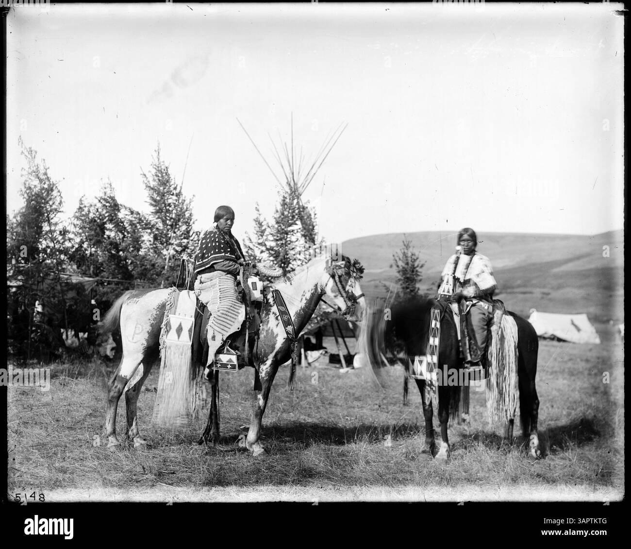 A photograph of Nez Perce Indian women in traditional regalia, riding ...