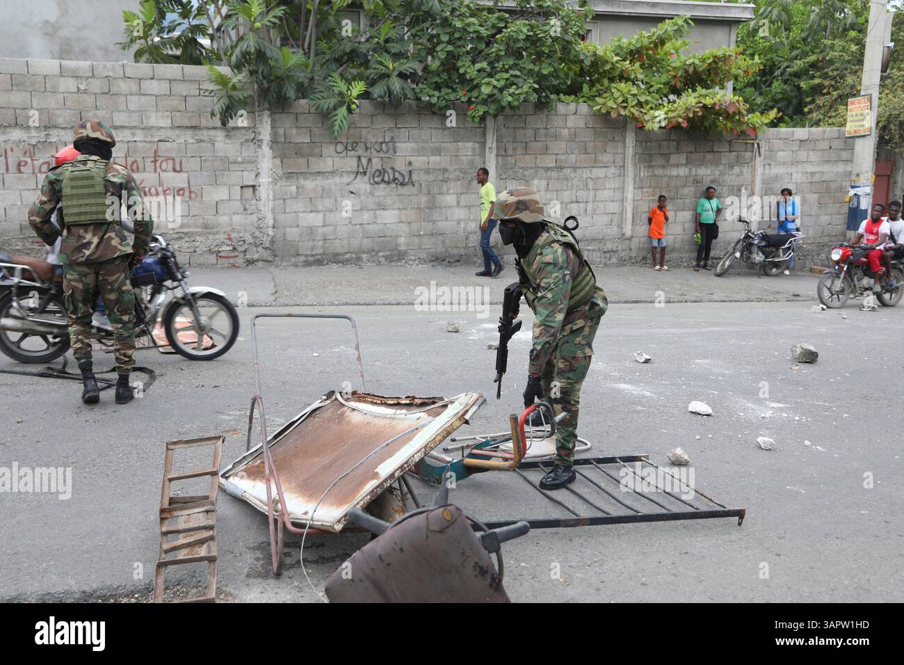 Haitian army soldiers remove barricade placed by demonstrators ...