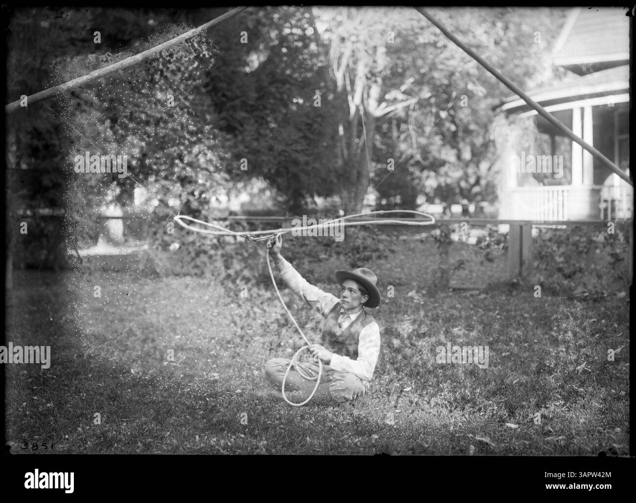 This photograph captures L.E. McCoy performing trick roping, a popular ...
