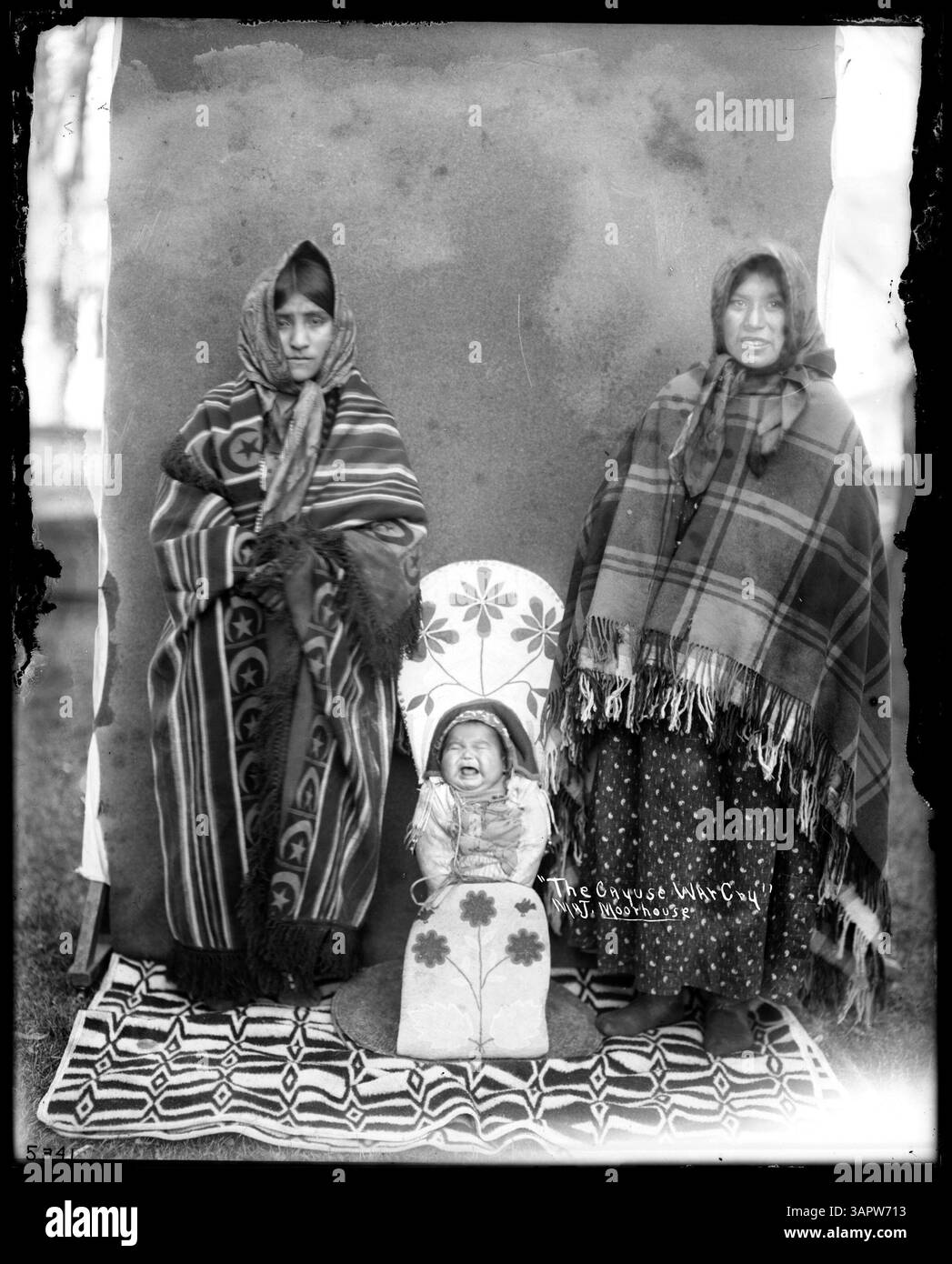 Photograph of tribal women with an infant in a cradle, showcasing ...
