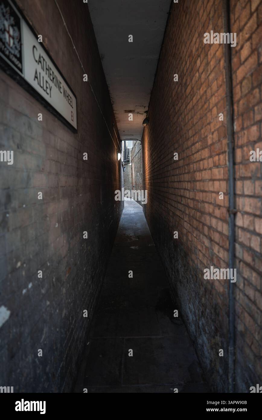 Narrow alleyway named Catherine Wheel Alley in London, flanked by aged ...