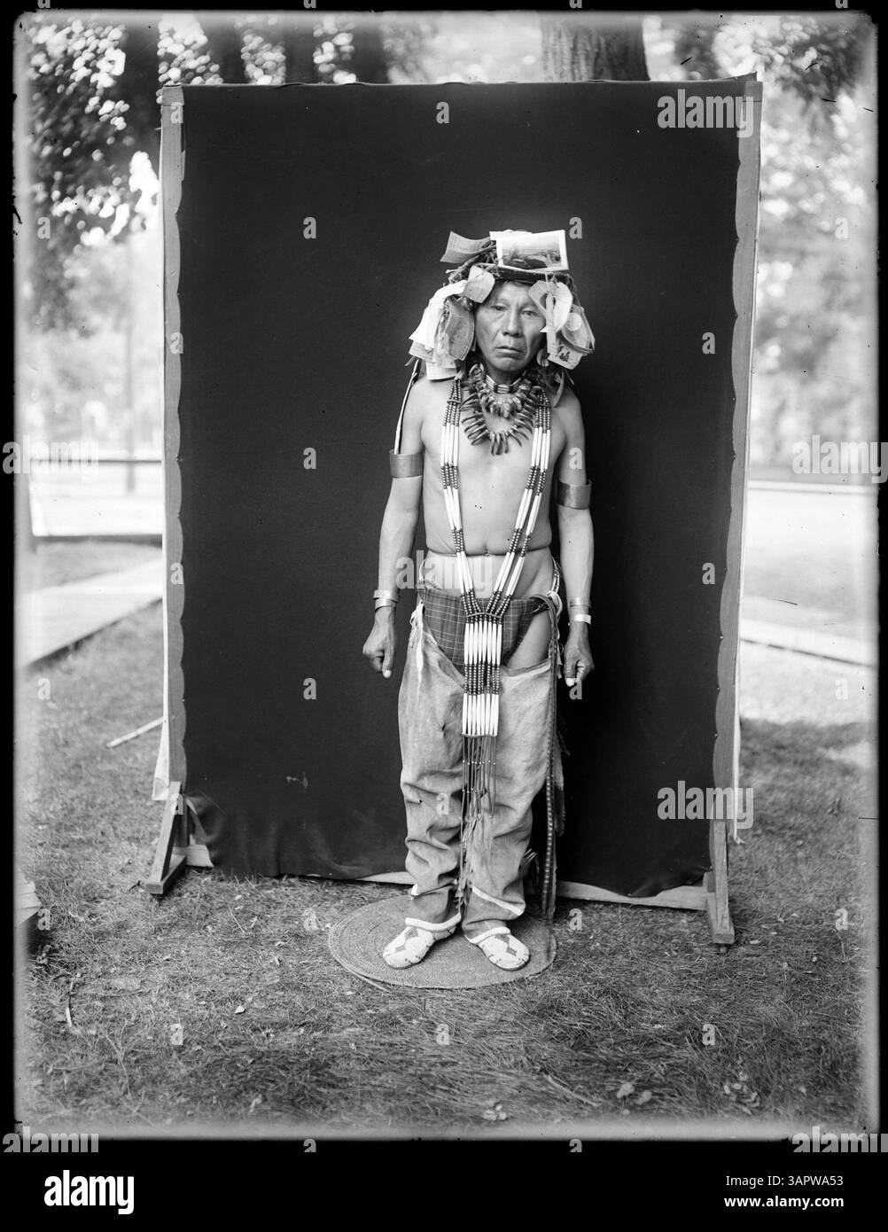 A tribal man in regalia is shown in this portrait, highlighting the ...