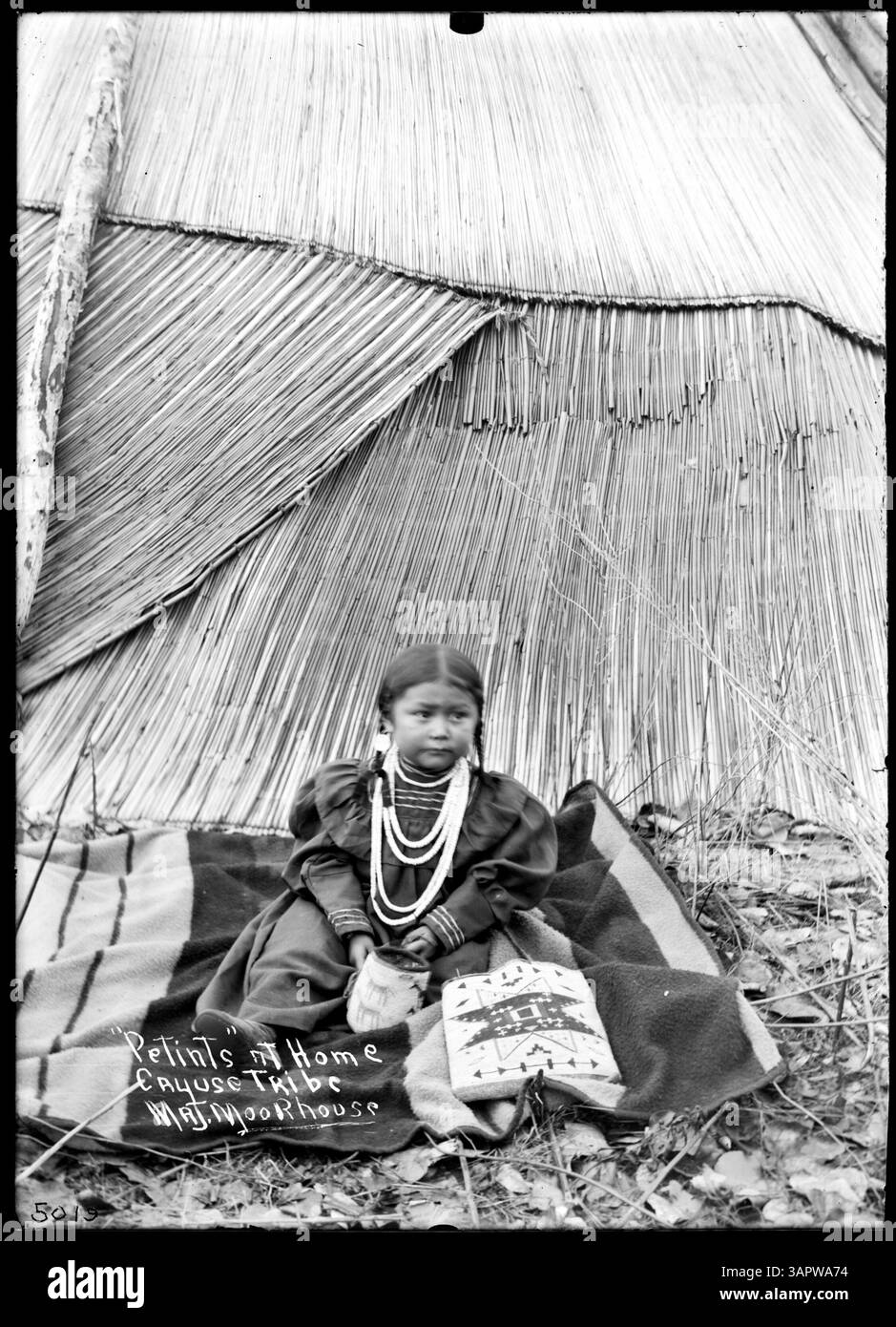 This Lee Moorhouse photograph captures a Cayuse child standing outside ...