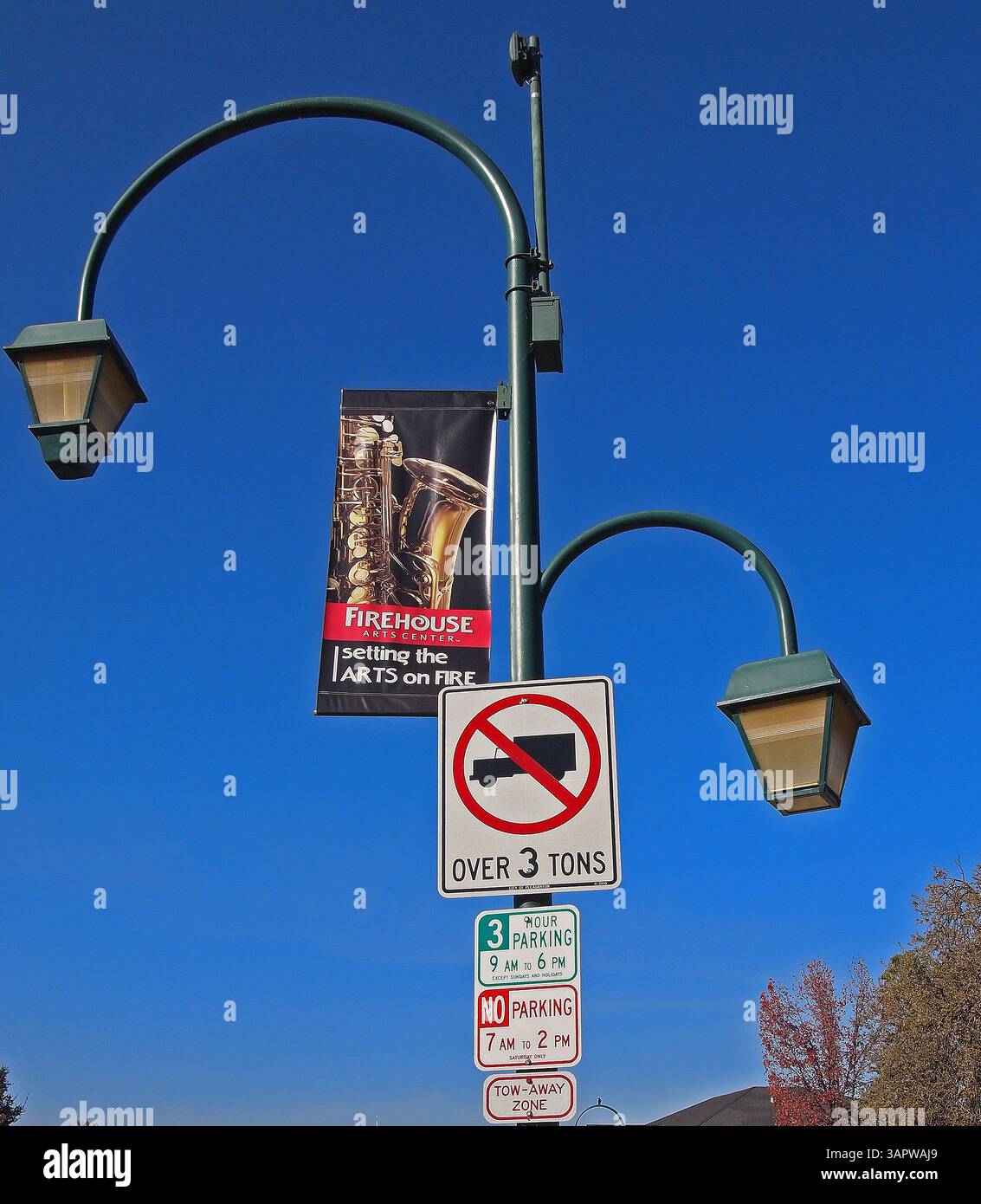 FireHouse Arts Center banner, street signs on a light pole in ...