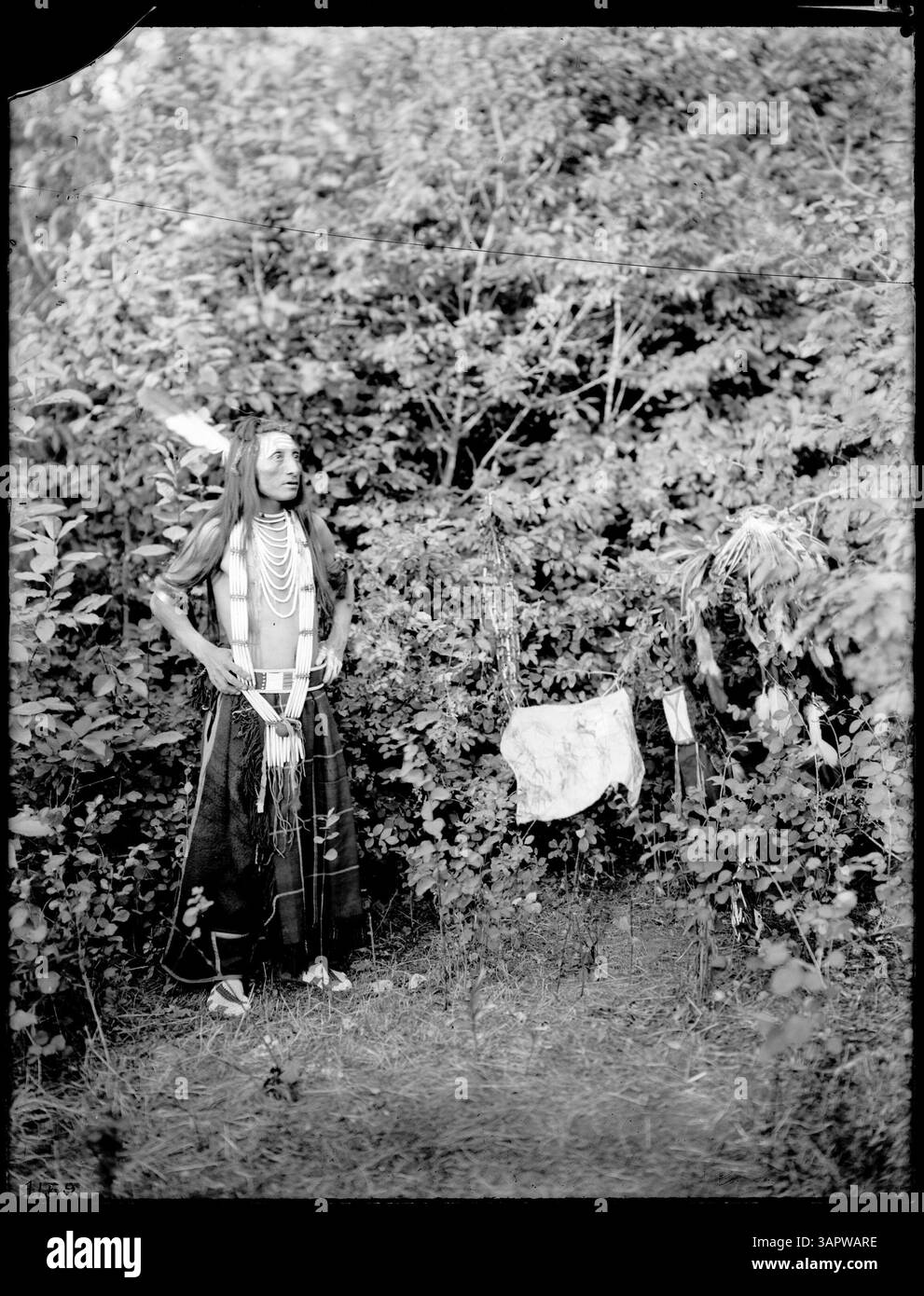 This photograph shows Sequyene, a Walla Walla Indian, in regalia with a ...