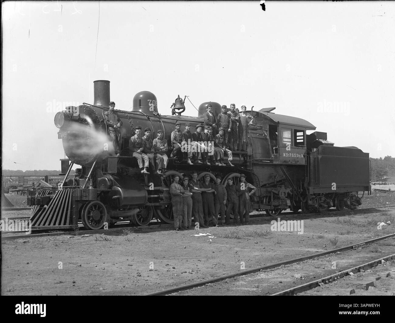 This image features a new Soo Line Locomotive with a train crew posed in a rail yard. The ...