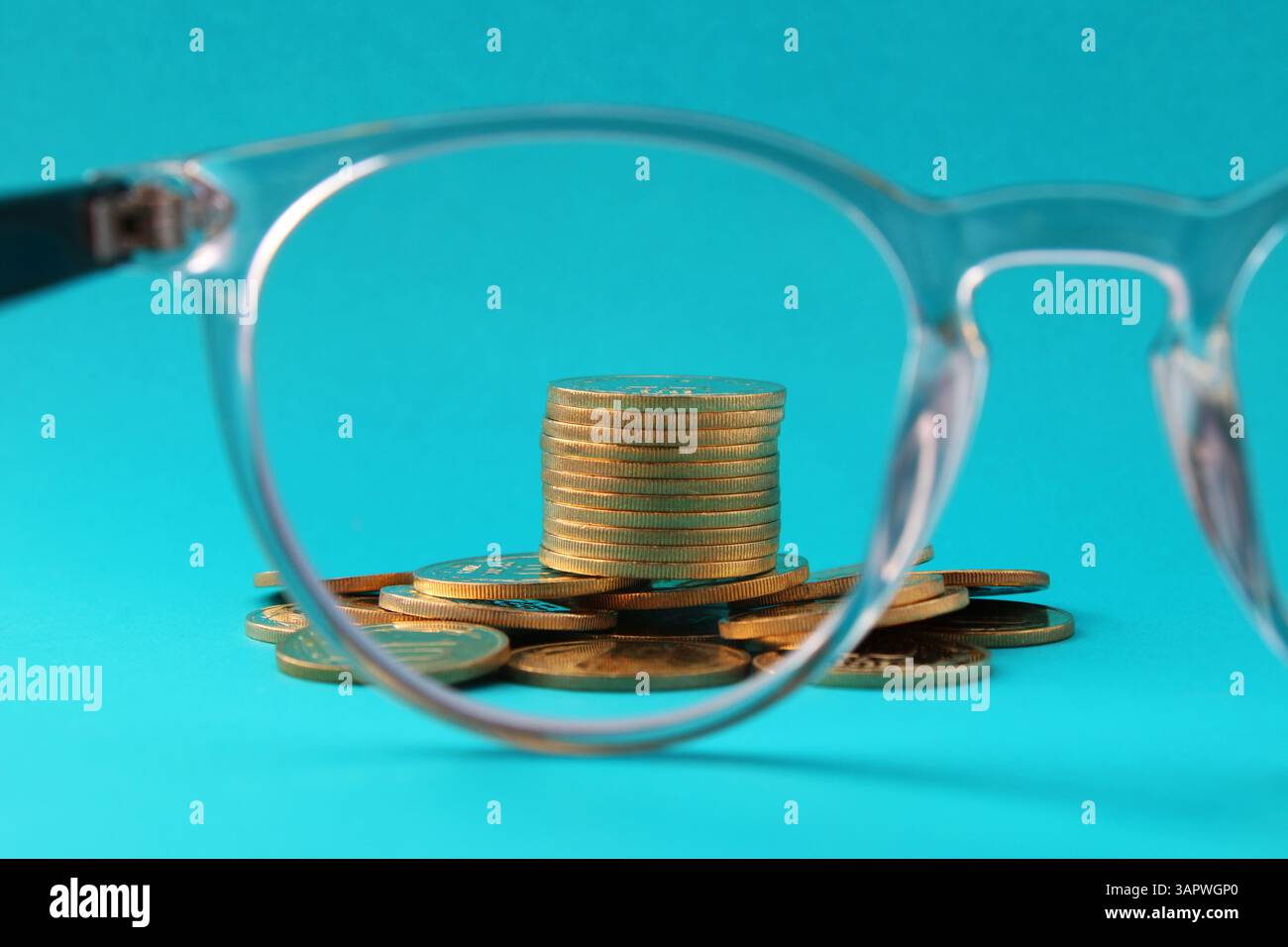 Optical lenses magnify vision to find a group of coins Stock Photo - Alamy