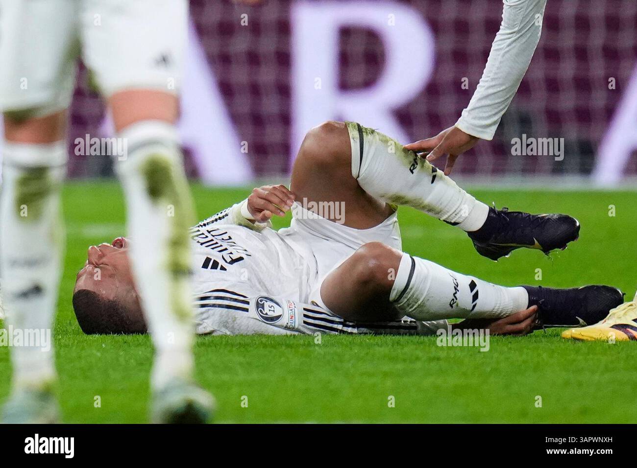 Real Madrid's Kylian Mbappe grimaces on the ground after getting ...