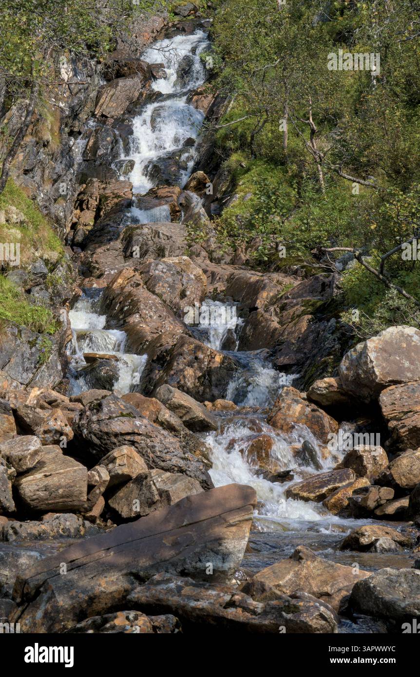 A scenic photo from Norway showing a cascading mountain stream flowing over rugged rocks Stock ...