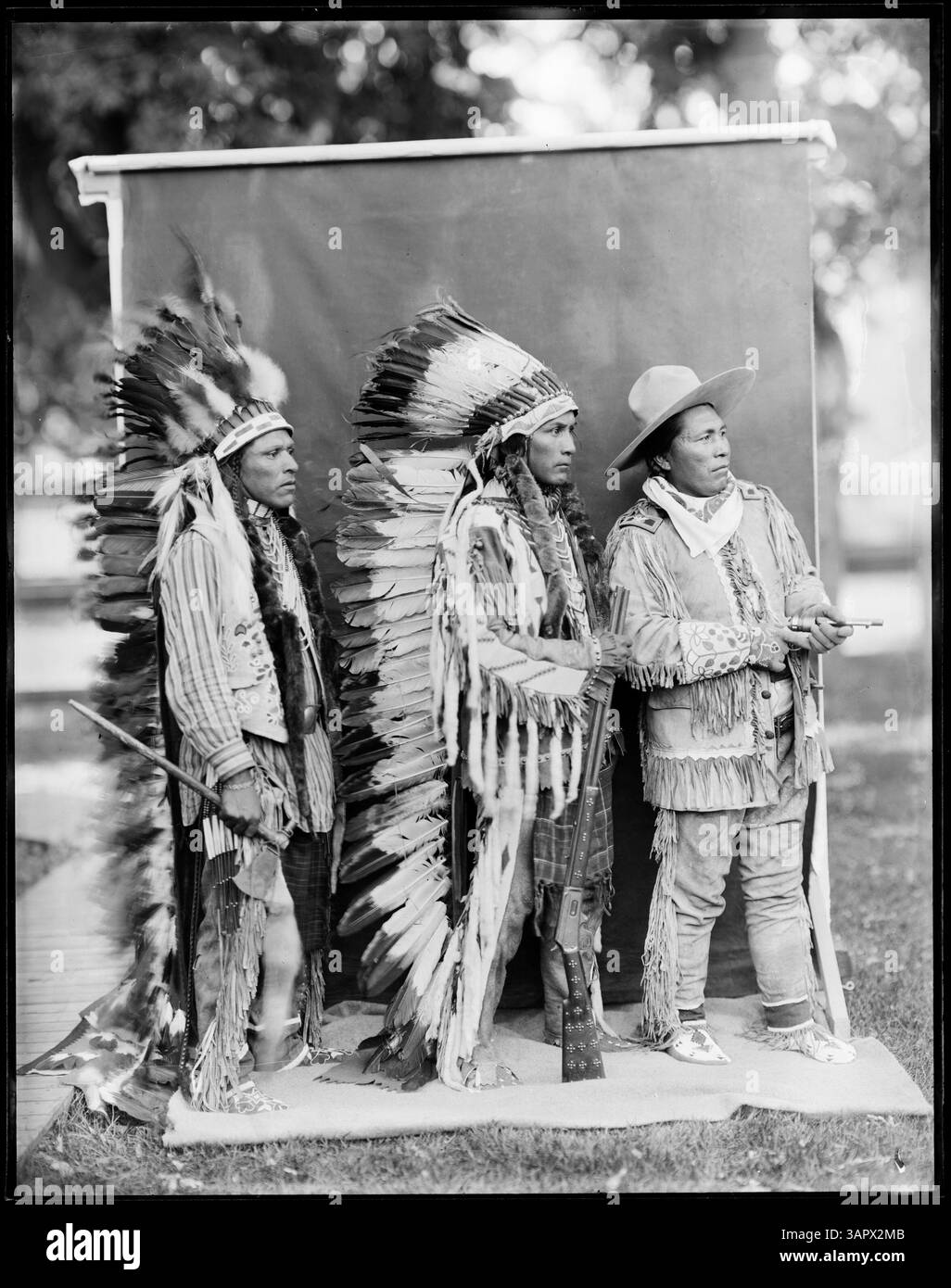 Photograph by Lee Moorhouse showing three tribal men, one dressed in ...