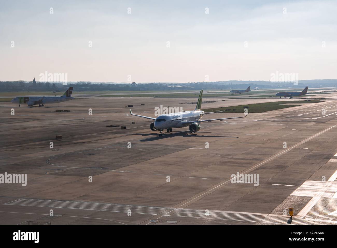 Airport Runway with Airplanes and a Tower on the Horizon Stock Photo ...