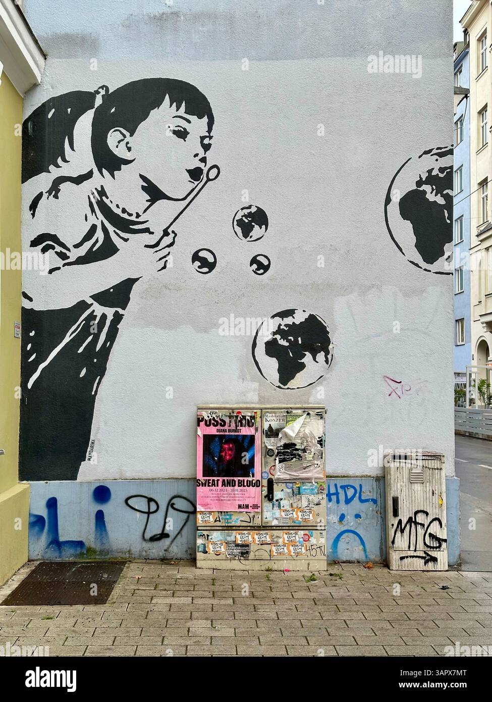 Street art of a girl blowing bubbles looking like planet earth by ...