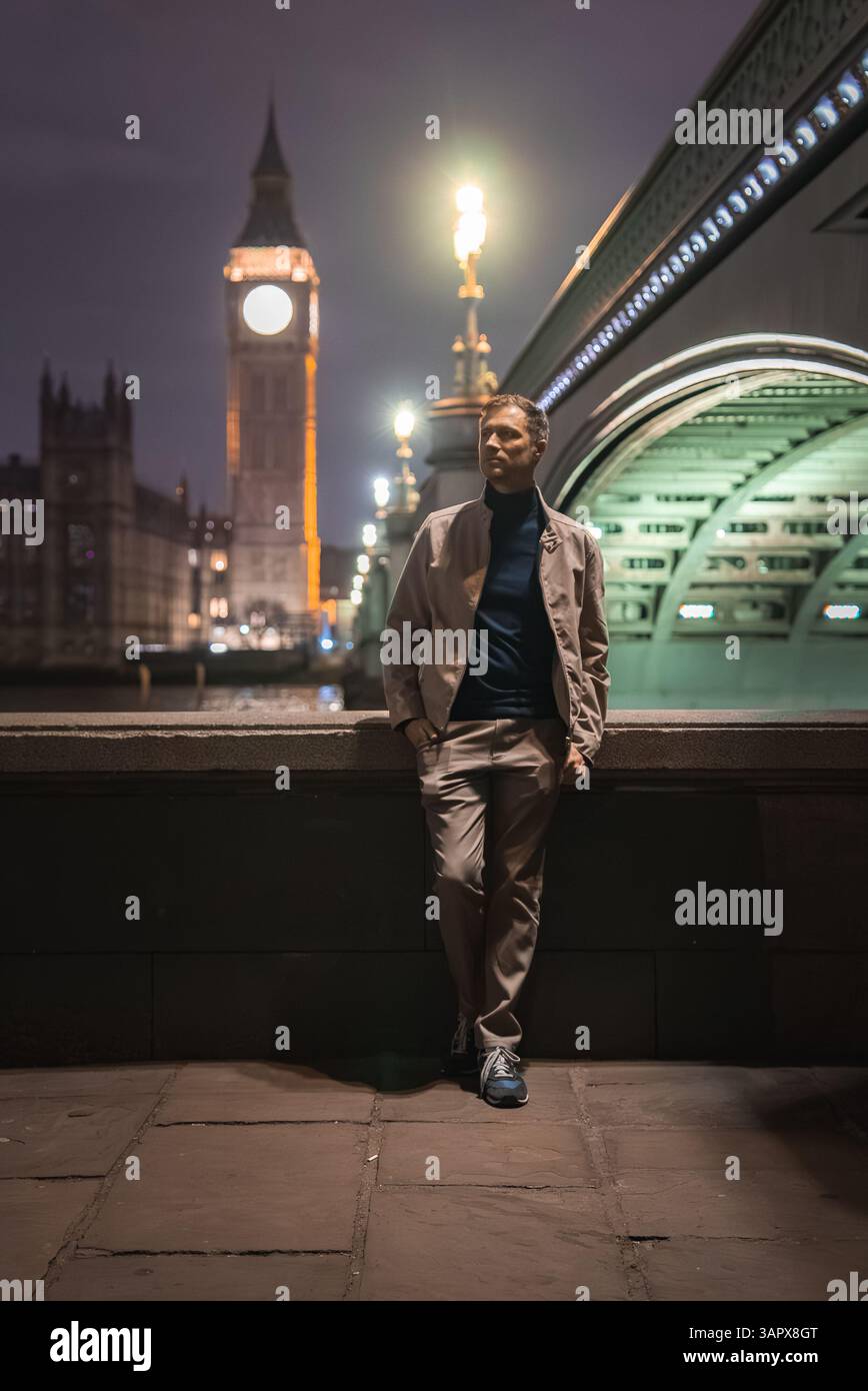 Man Leaning on Railing at Night with Big Ben and Parliament Lit Stock ...