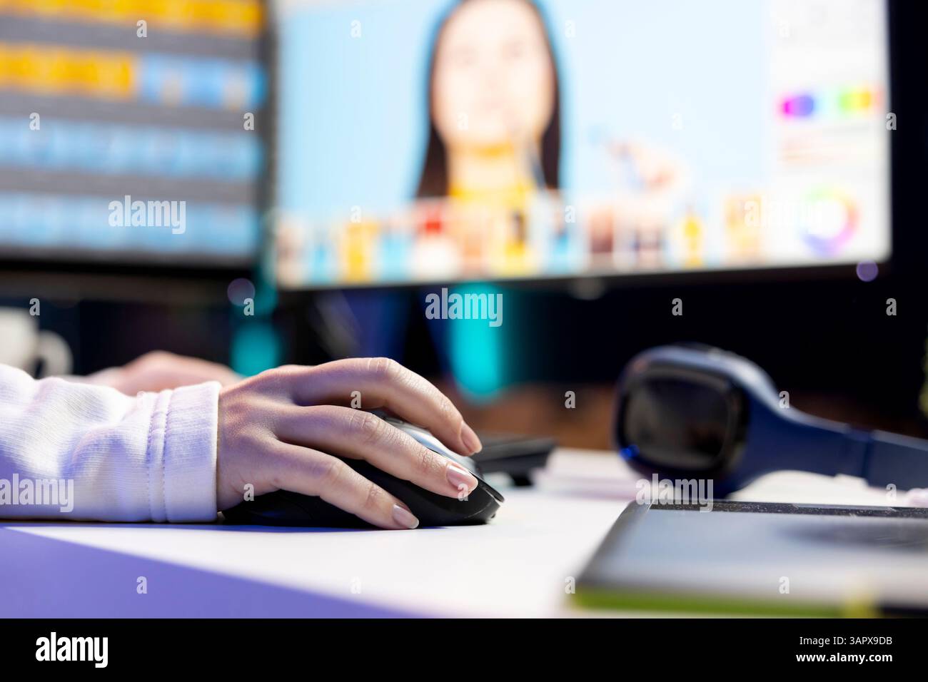 Photo editor color correcting photographs in creative studio using ...