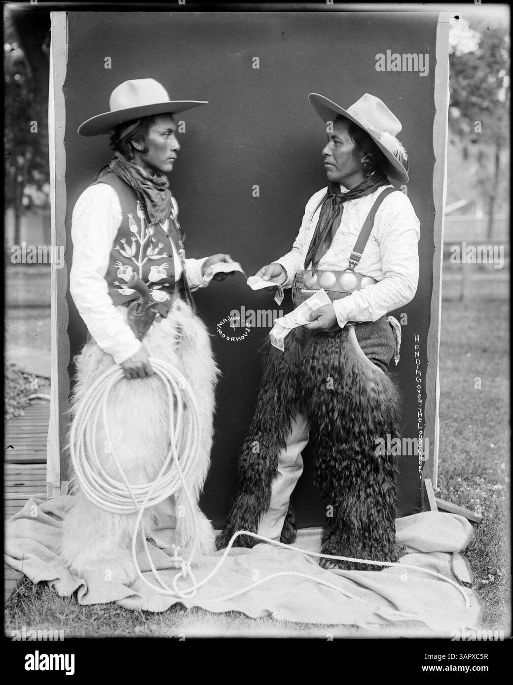 This photograph by Lee Moorhouse shows two cowboys in the American West ...