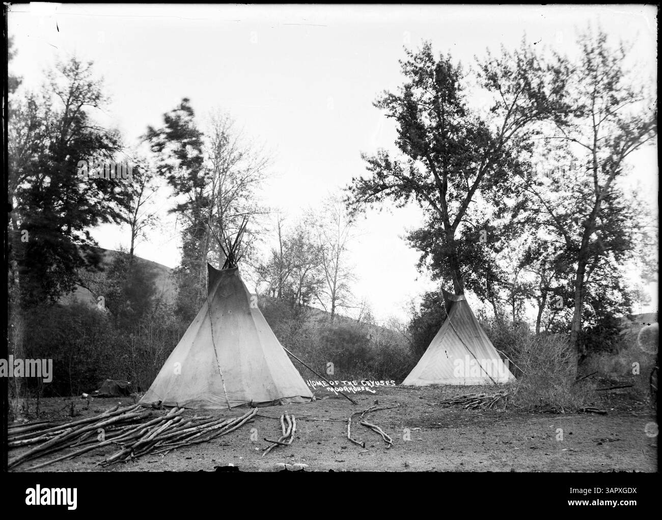 This photograph by Lee Moorhouse features two tipis, labeled 'Home of ...