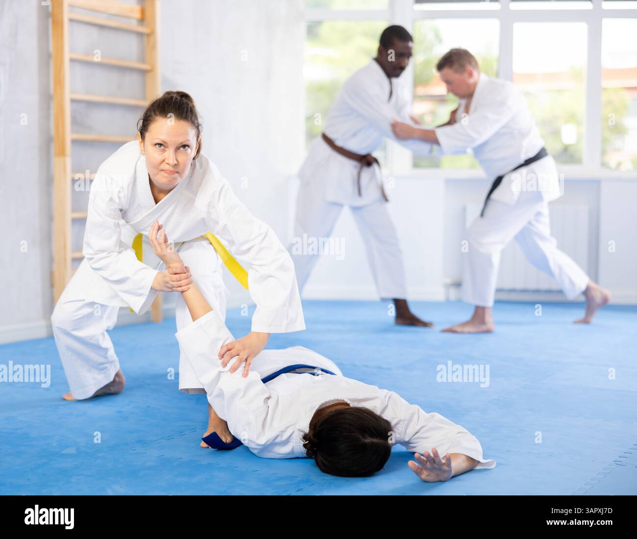 Female athletes playing Judo in sport hall Stock Photo - Alamy